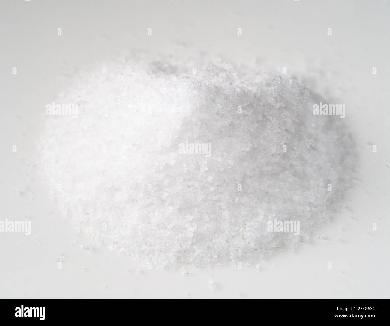 handful of finely ground sea salt closeup on white plate Stock Photo ...