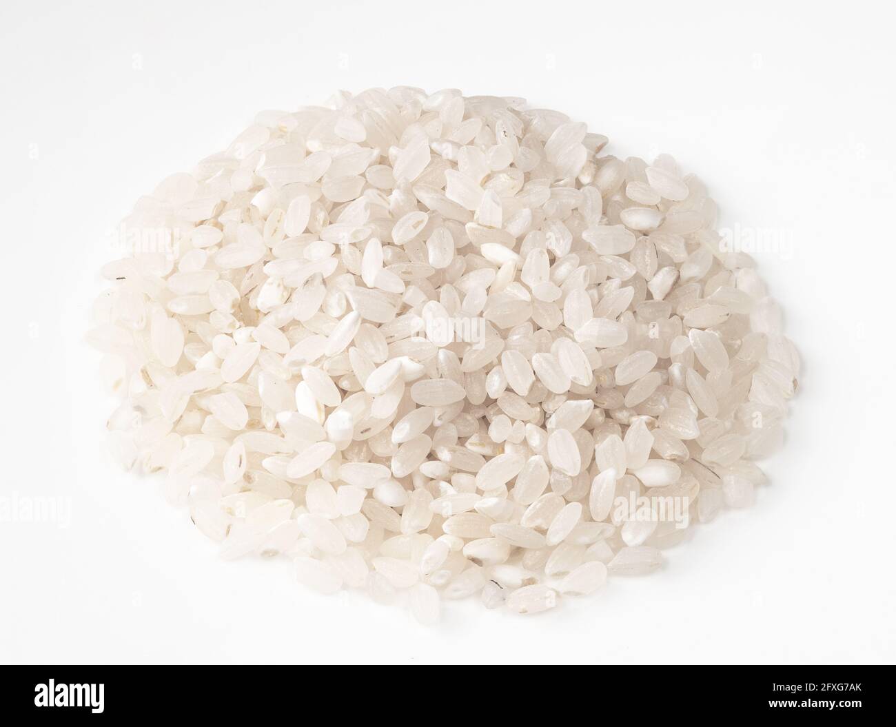 handful of raw medium-grain polished rice closeup on white background ...
