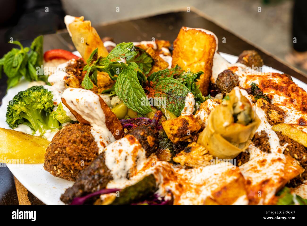 A mixed plate of Arabic Lebanese food including falafel, halloumi ...