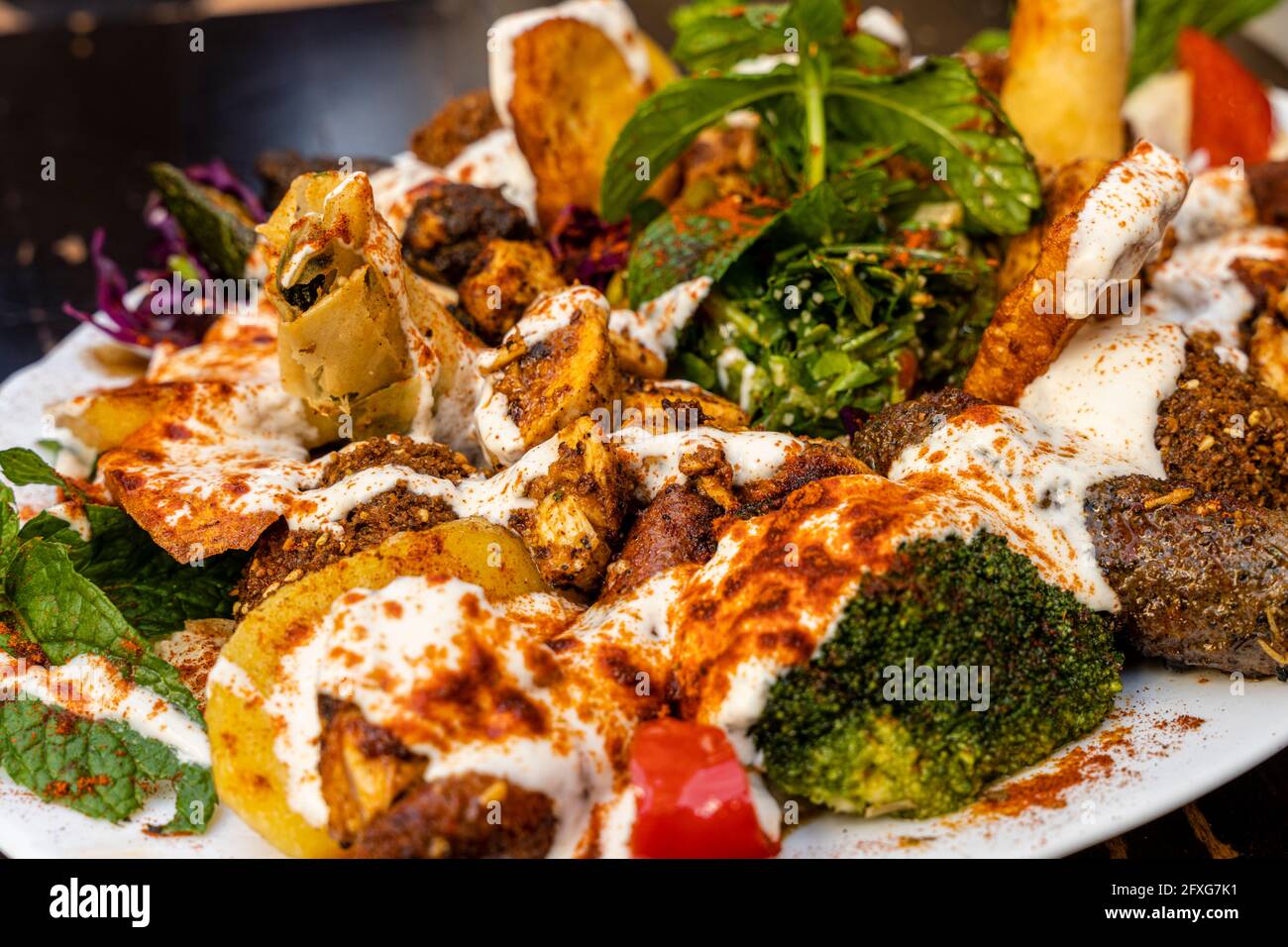 A mixed plate of Arabic Lebanese food including falafel, halloumi ...