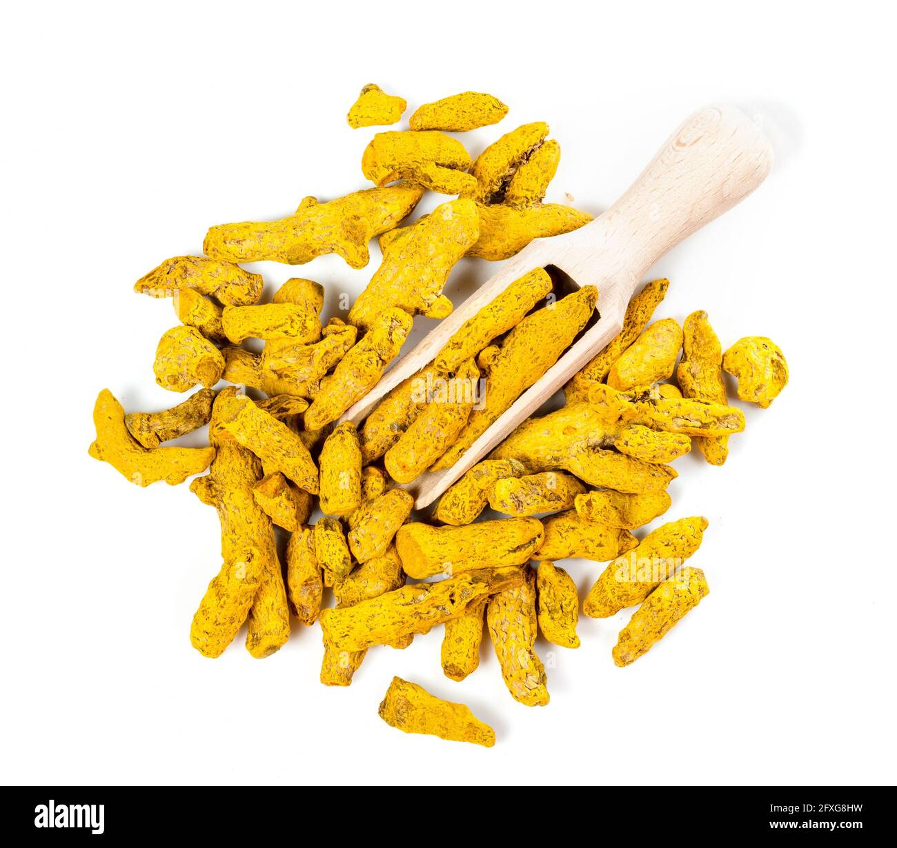 top view of wood scoop on pile of dried roots of Turmeric (Curcuma ...