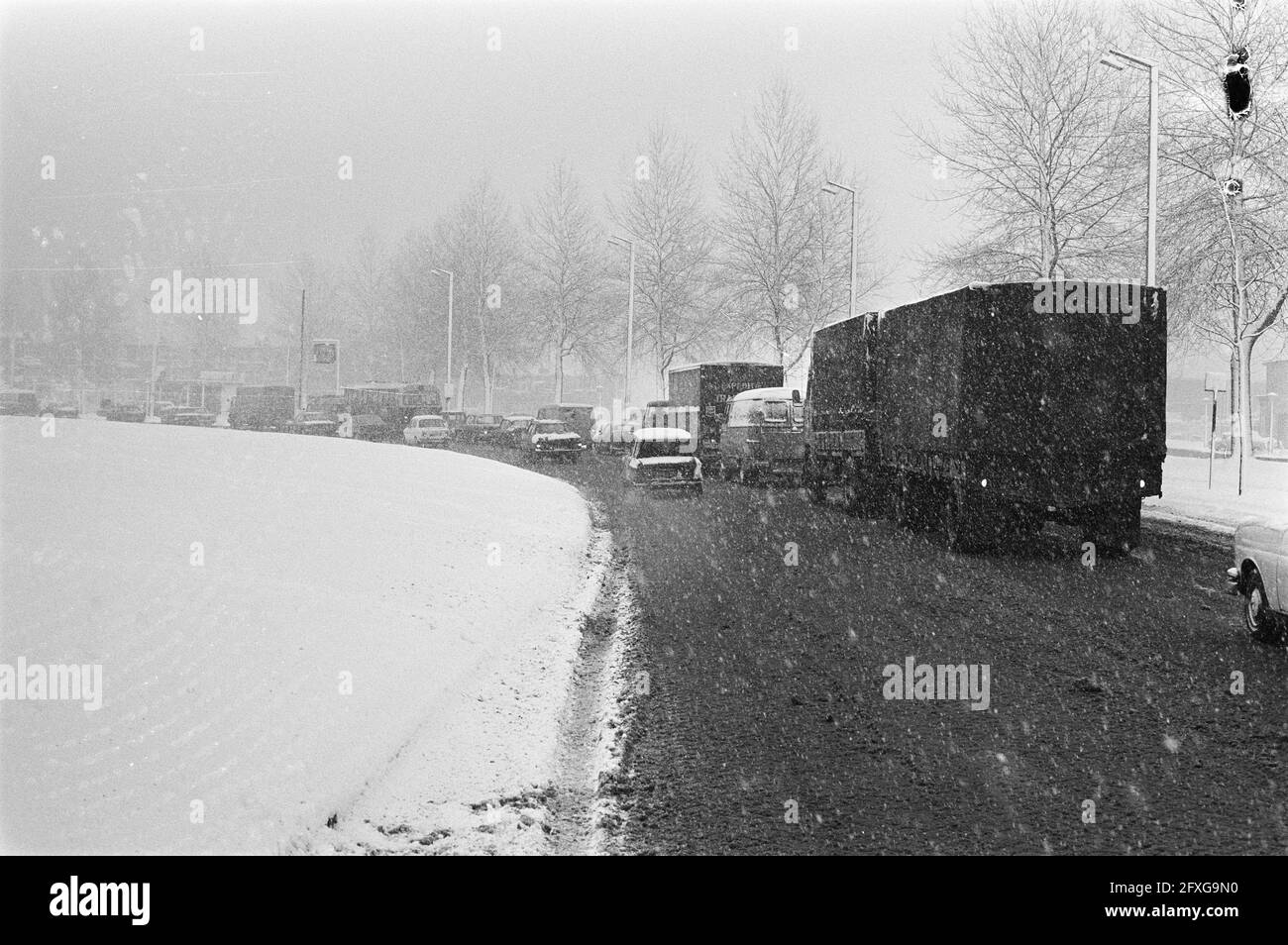 Traffic suffers from snow. Car in traffic jam on Haagsche road ...