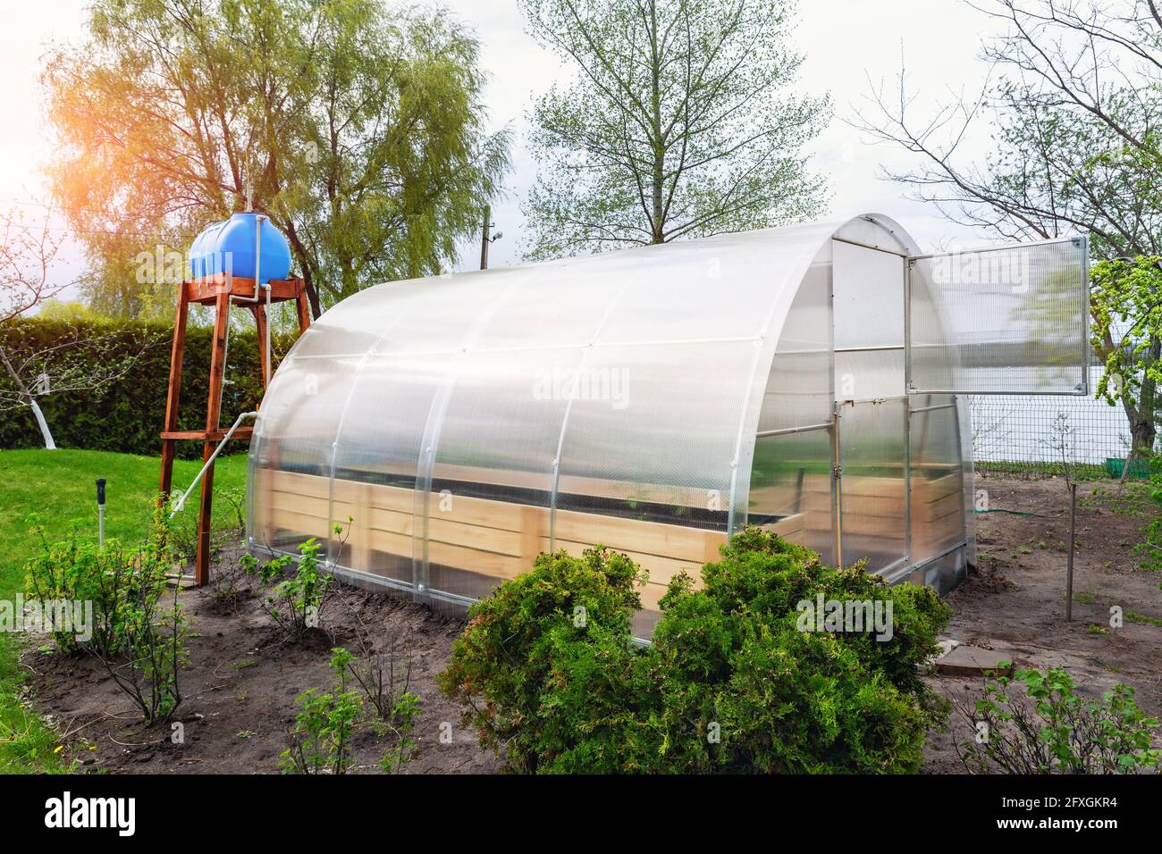 DIY wooden base with elevated water storage tank for autonomous drip ...