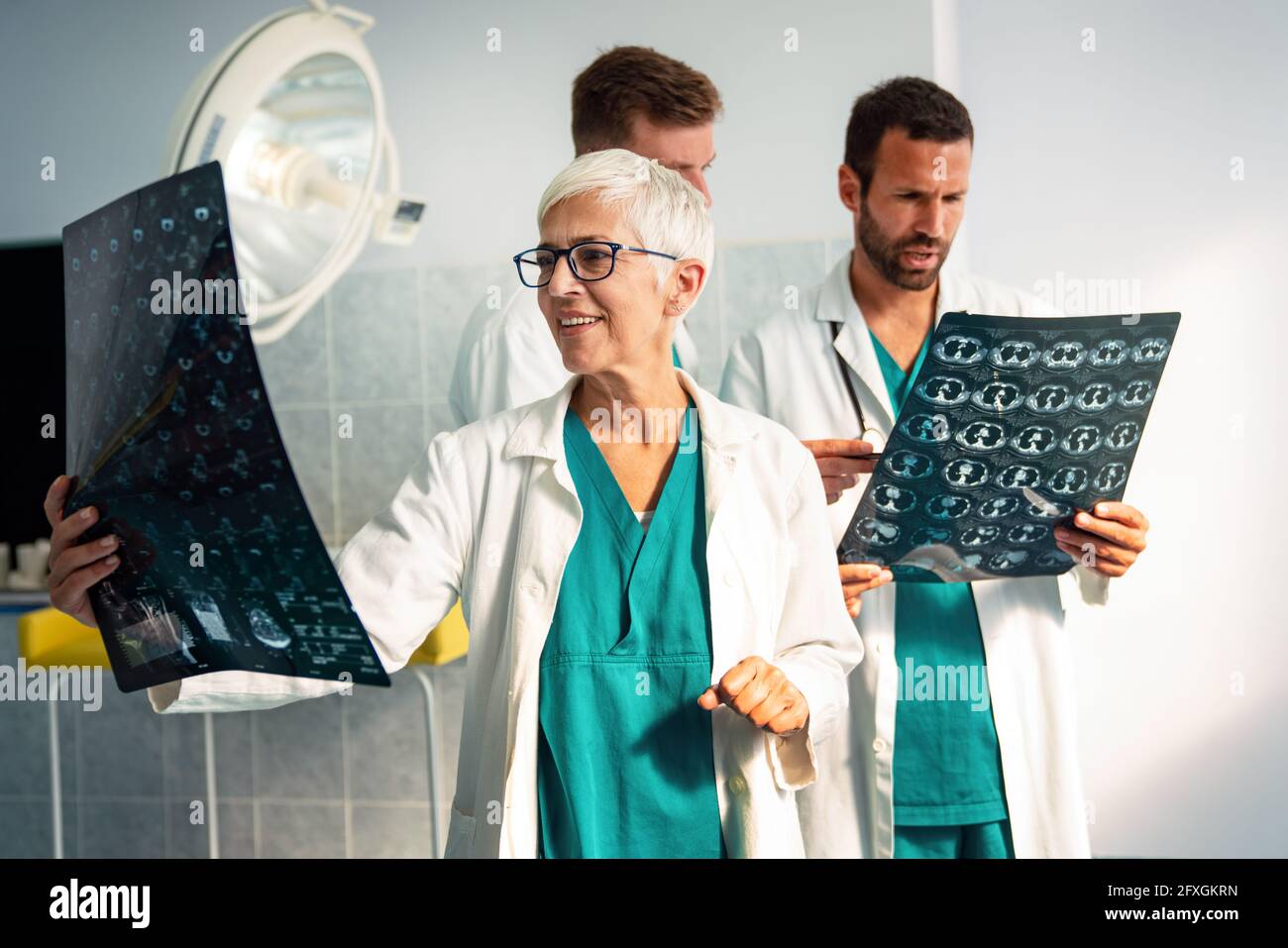 Group of doctor looking at ct scan at hospital to make diagnosis Stock ...