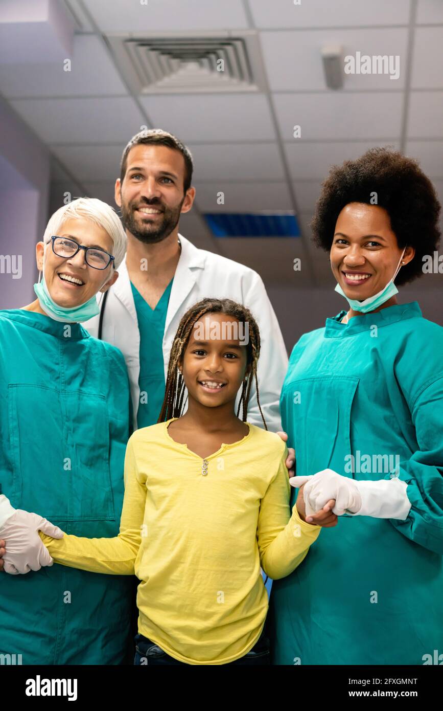 Team of experienced highly qualified doctors with child patient after a ...
