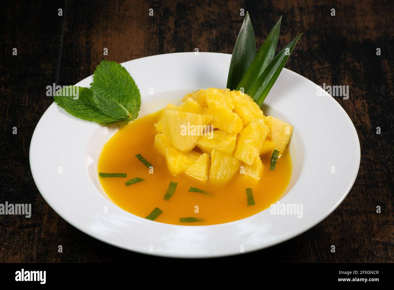 Fresh pineapple dessert recipe with mint orange coulis Stock Photo - Alamy