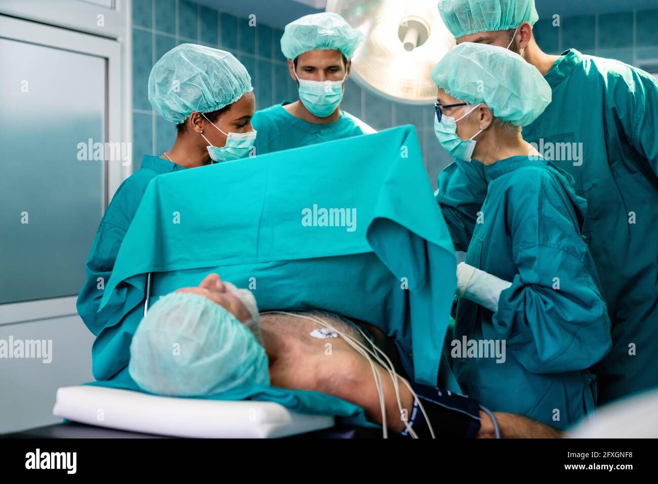 Surgery team operating in a surgical room Stock Photo - Alamy