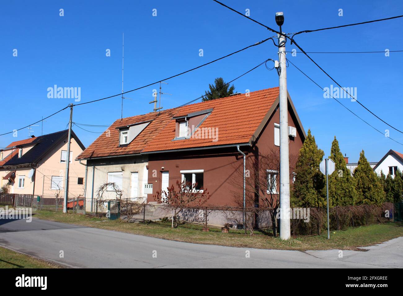 Half renovated small attached suburban street corner family house with two entrances and ...