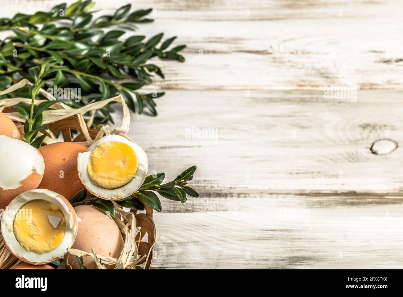 Fresh farm eggs in the basket and hard boiled egg isolated on white ...
