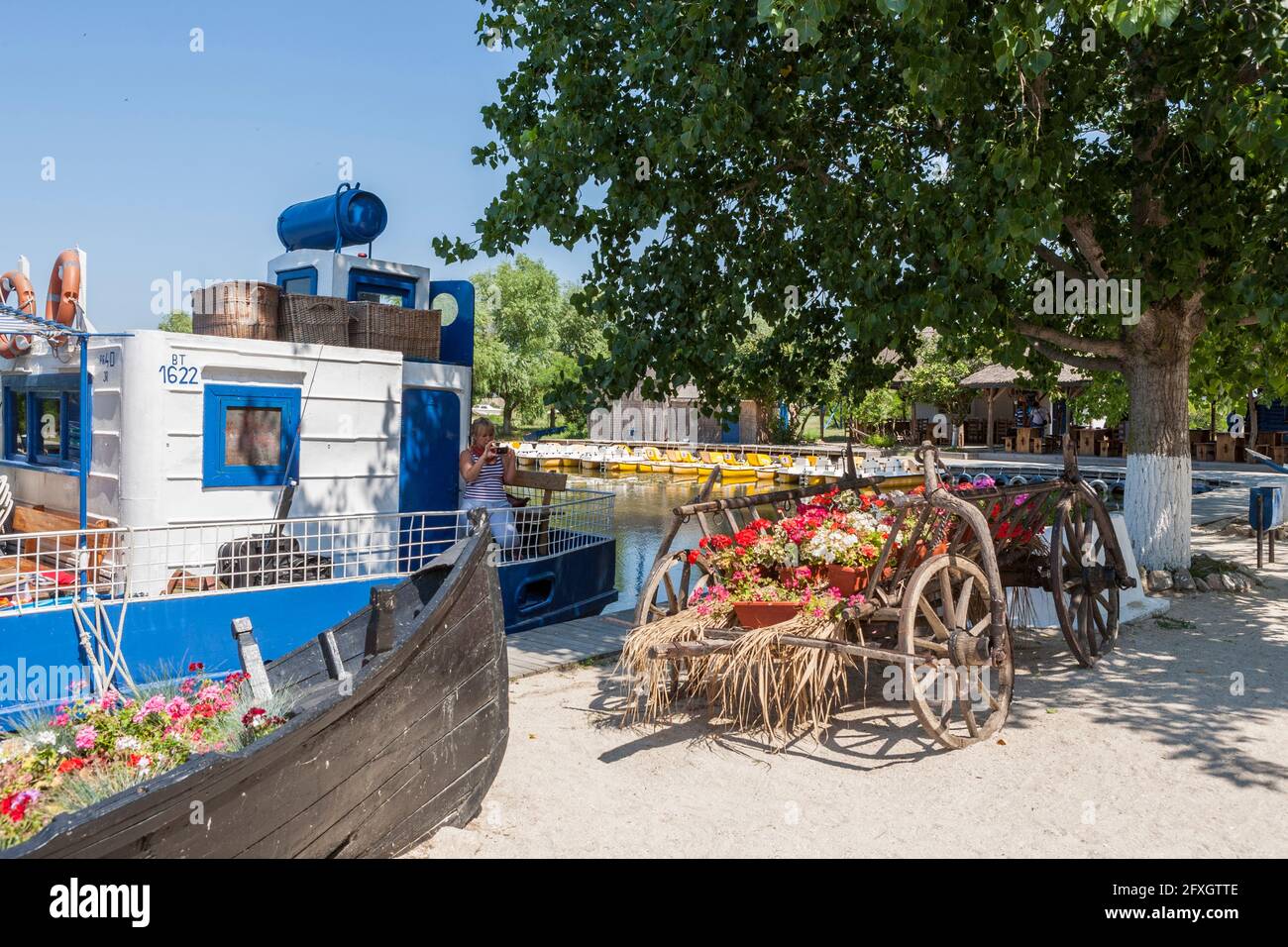 Gura Portitei village, boat filled with flowers, Portita peninsula at ...