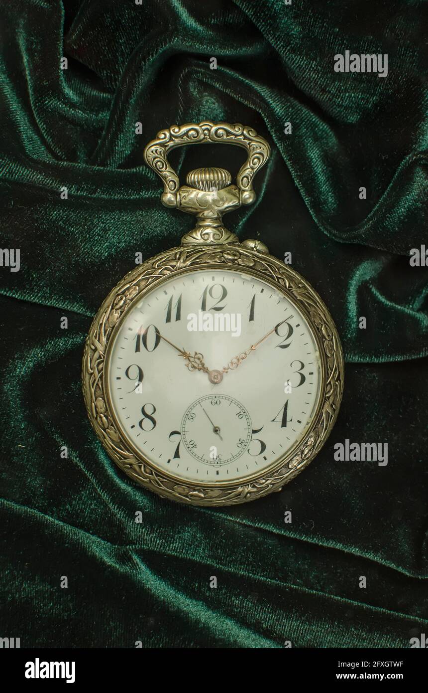 gold pocket watch on velvet fabric Stock Photo - Alamy