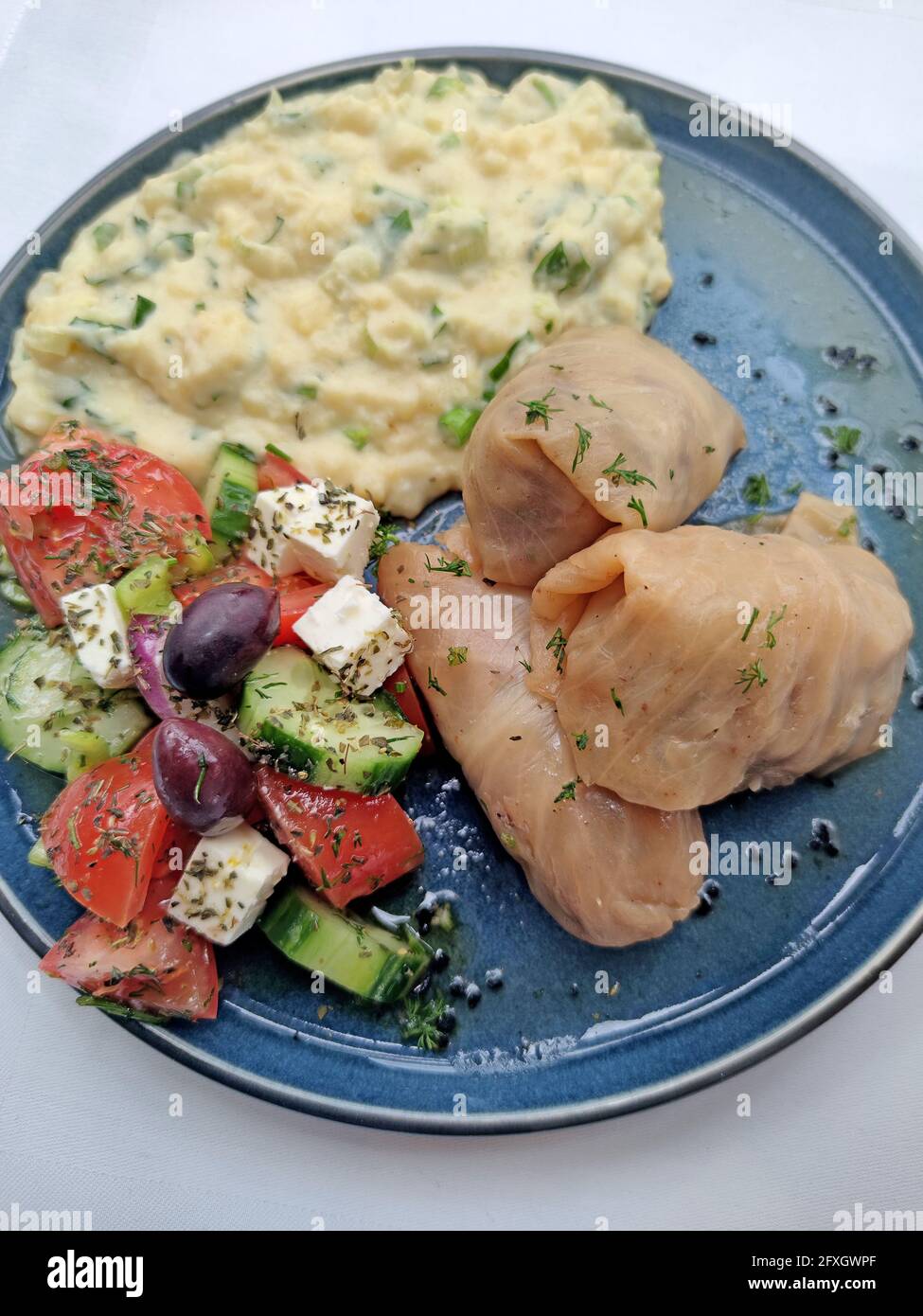 Greek traditional food with meat and vegetables in blue plate trendy ...