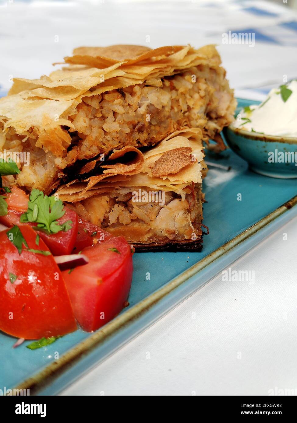 Greek traditional food with meat and vegetables in blue plate trendy ...