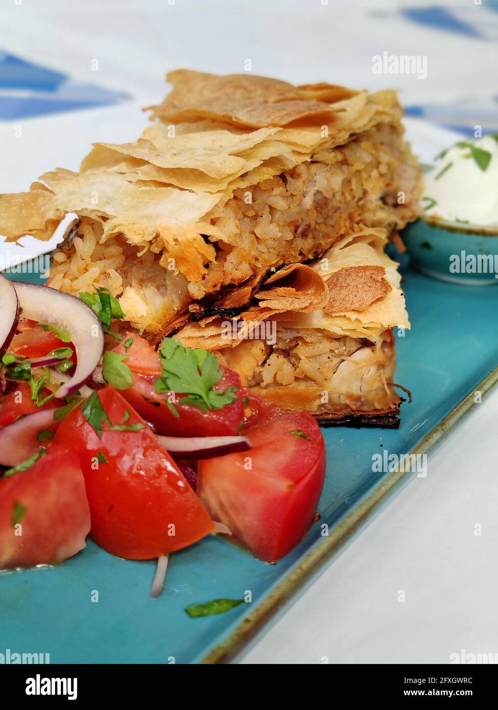 Greek traditional food with meat and vegetables in blue plate trendy ...