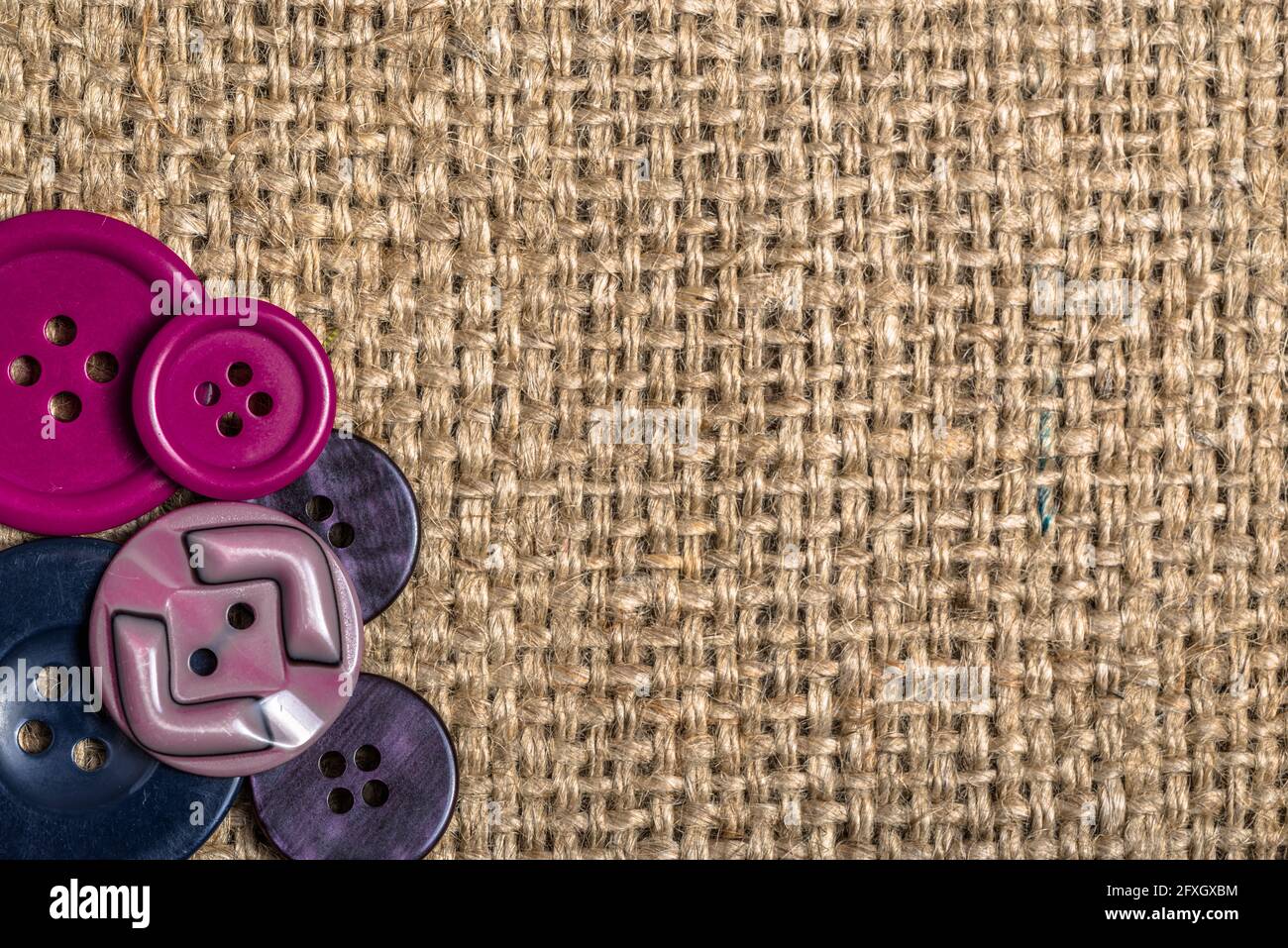 Sewing buttons on textile background Stock Photo - Alamy