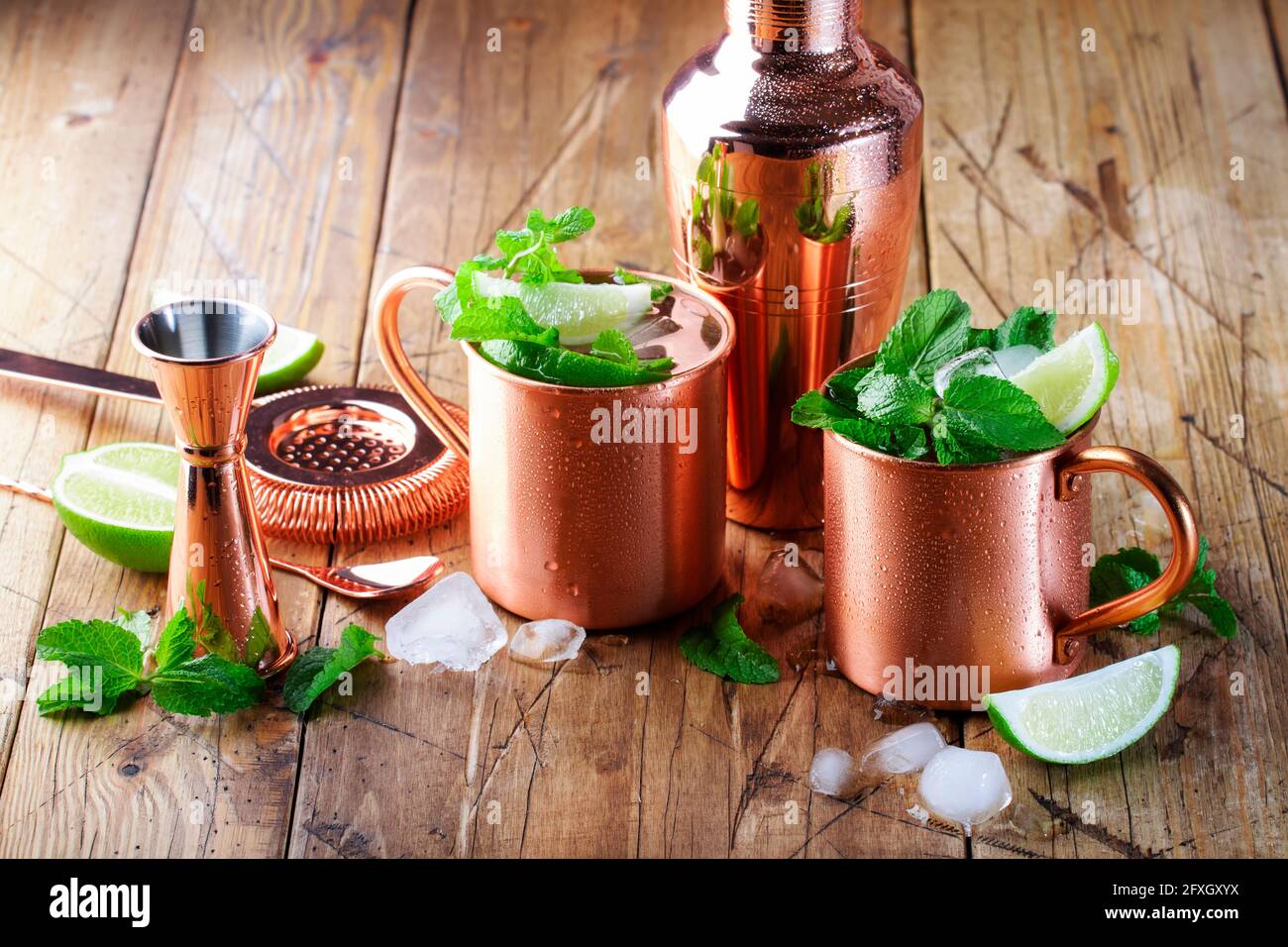 Moscow mule or mint julep alcoholic cocktail in copper mug with lime ...