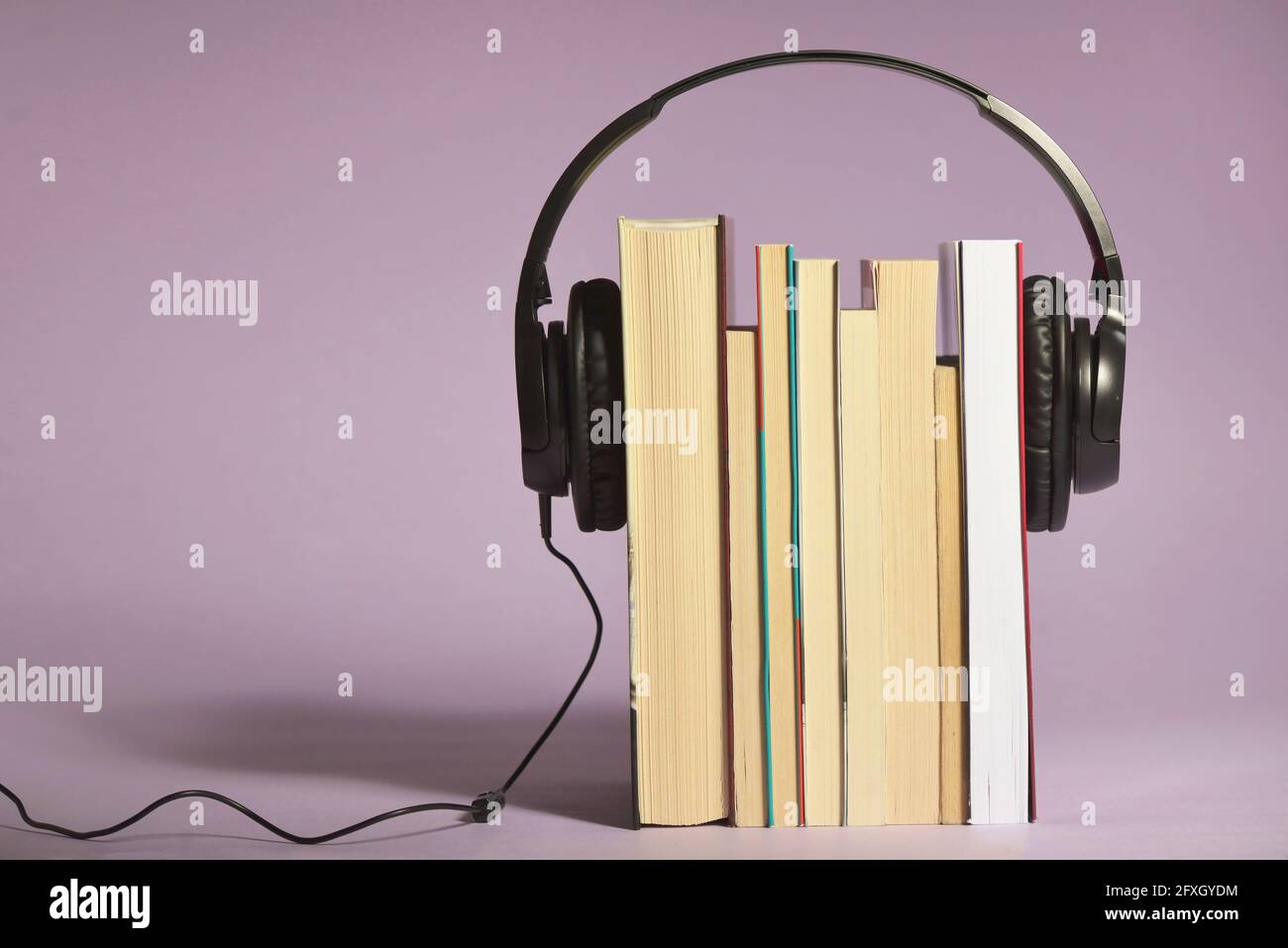 Audio books concept with books and headphones in studio Stock Photo - Alamy