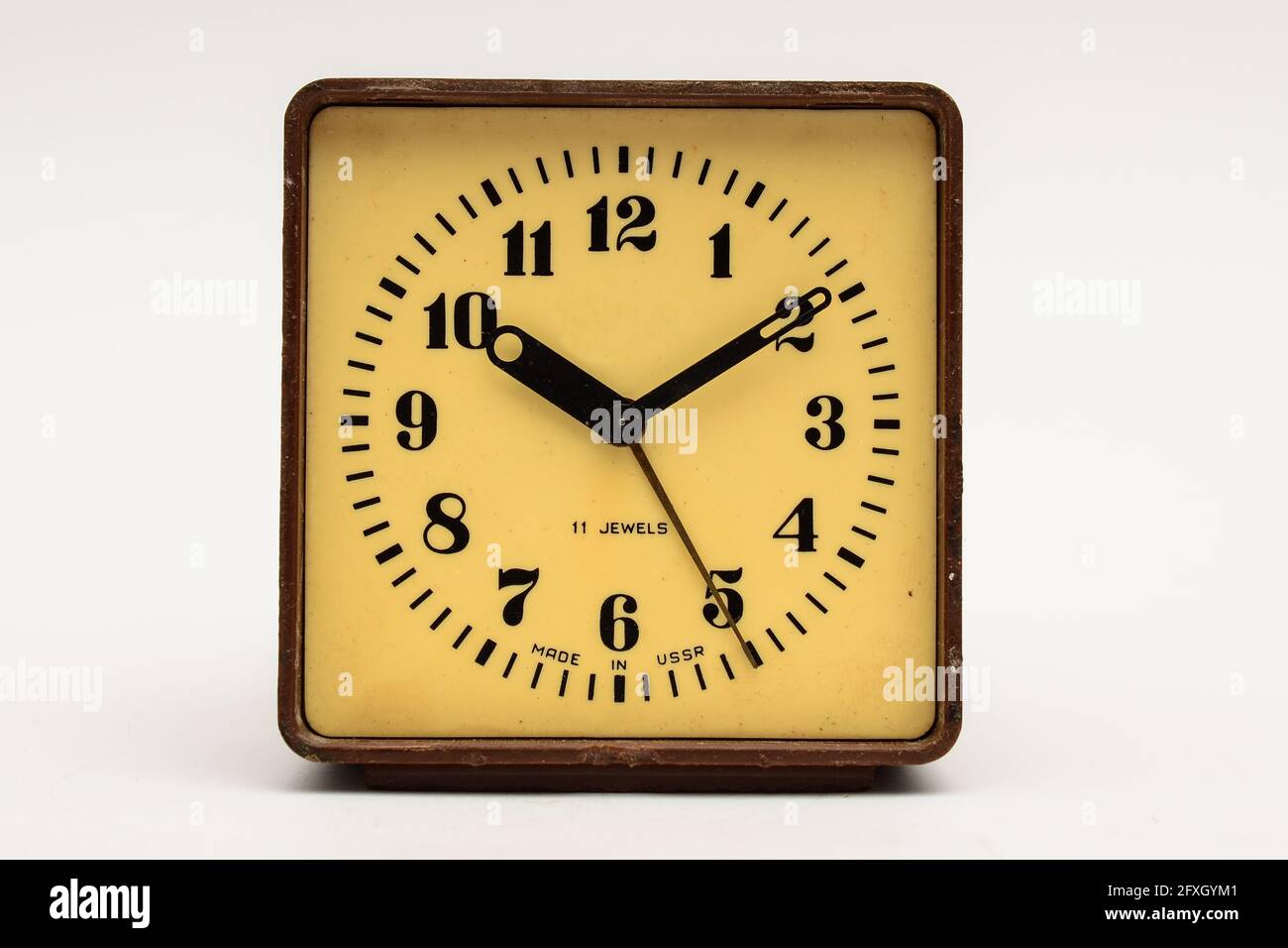Brown square alarm clock on a white background Stock Photo - Alamy