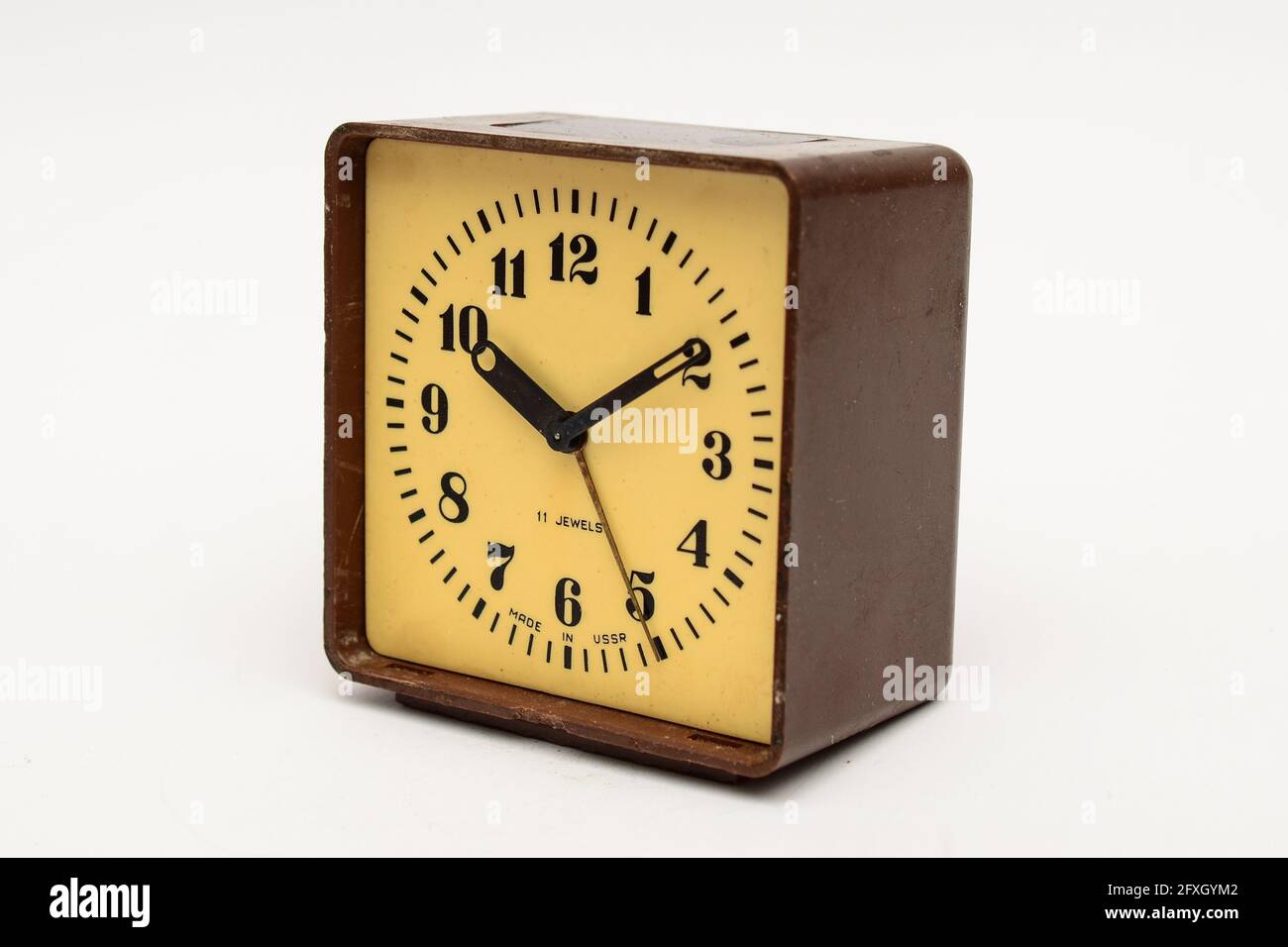 Brown square alarm clock on a white background Stock Photo - Alamy