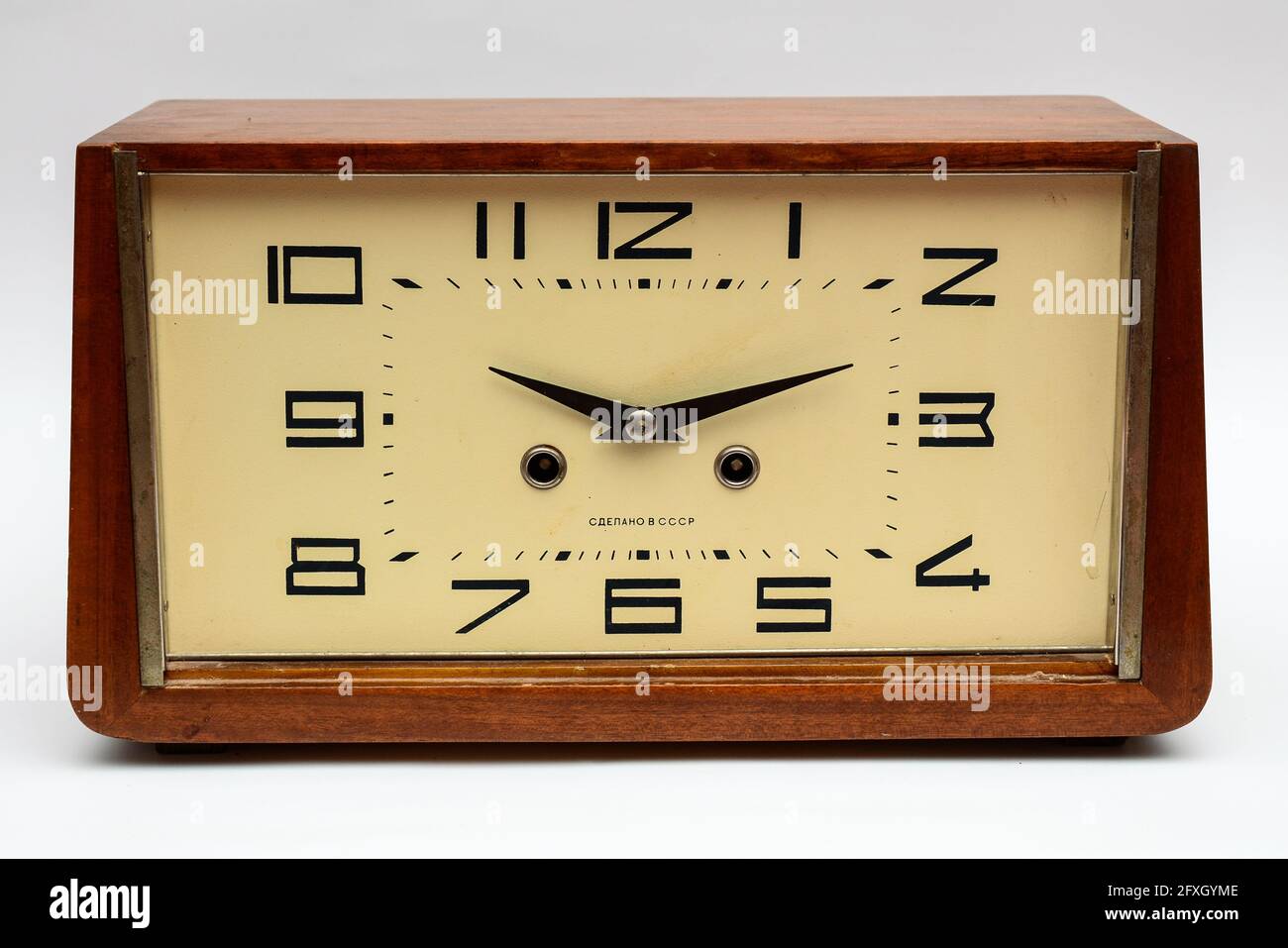 Wooden table clock on white background Stock Photo - Alamy