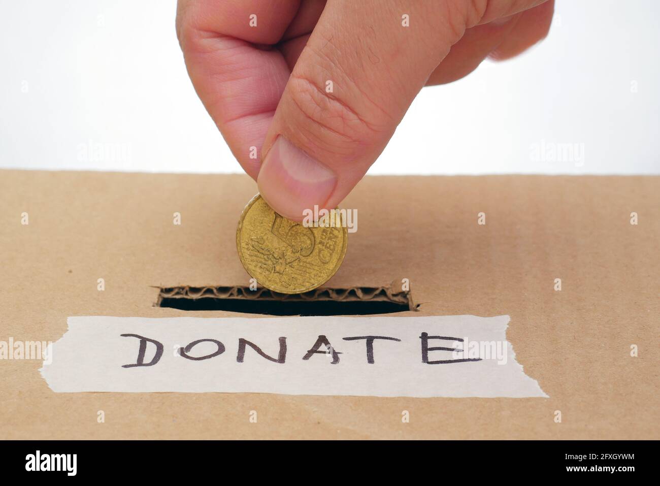 hand putting 50 eurocent coin in donation box Stock Photo - Alamy