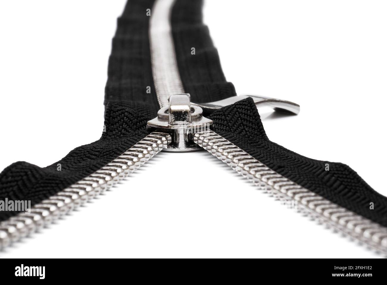 macro of open metal zipper with black fabric isolated on white ...