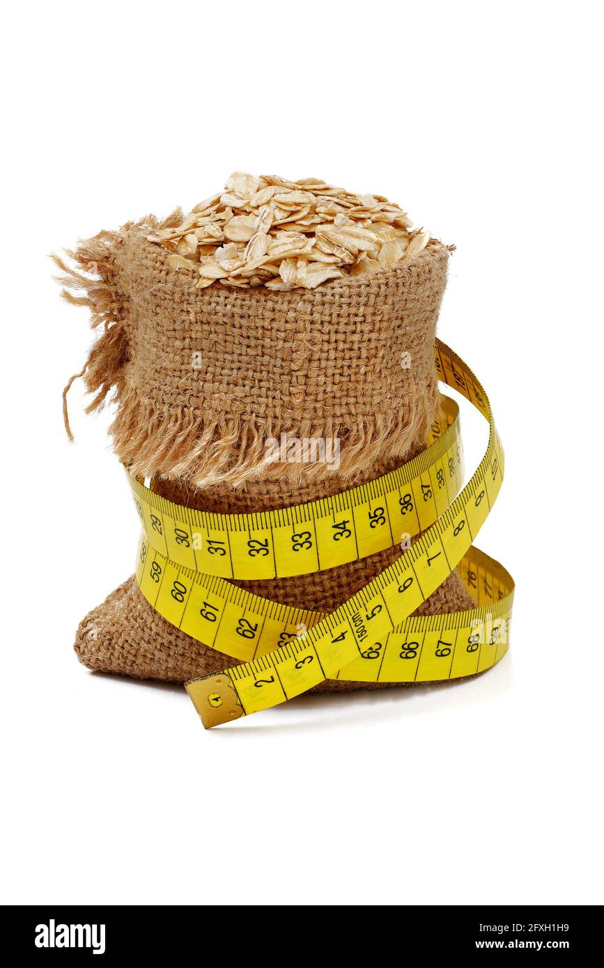 oat rolled cereals in full burlap sack with measure tape isolated on ...