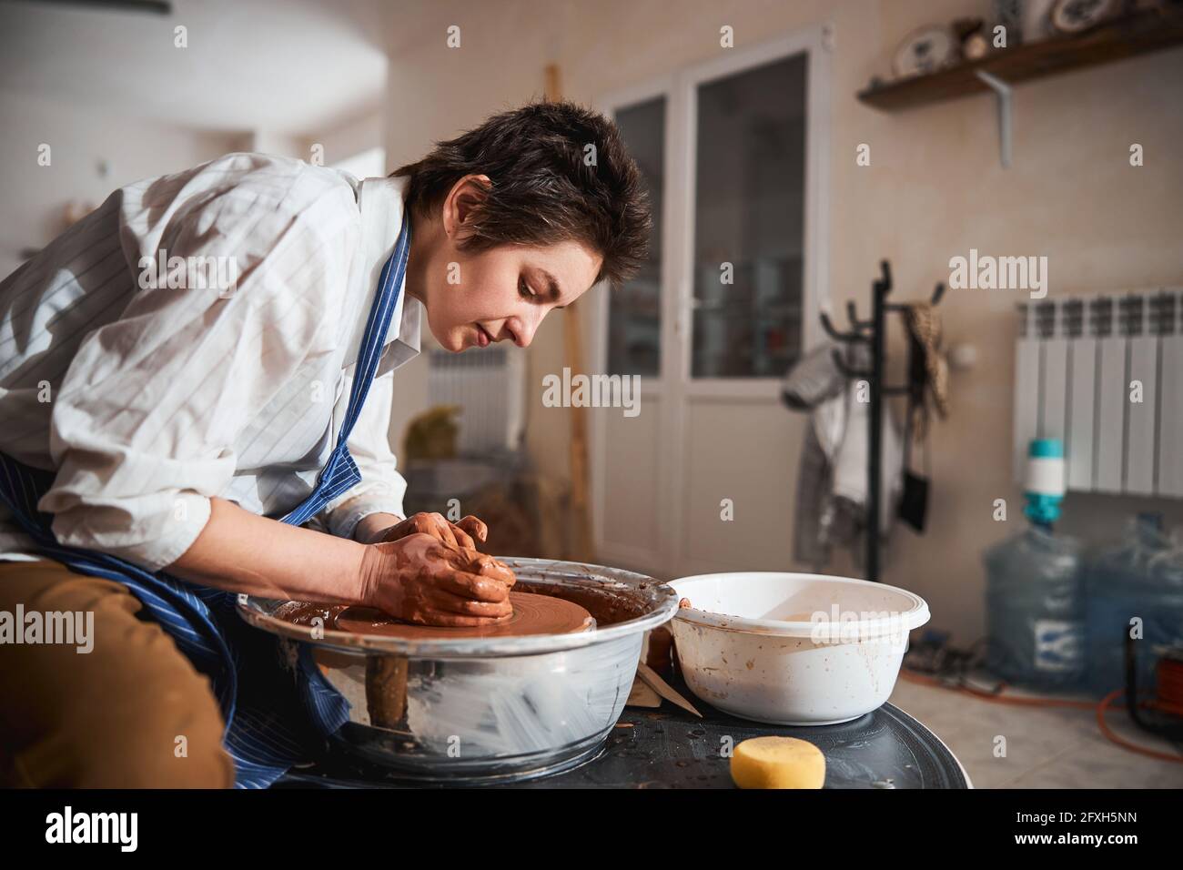 Concentrated female person making vase for sale Stock Photo - Alamy