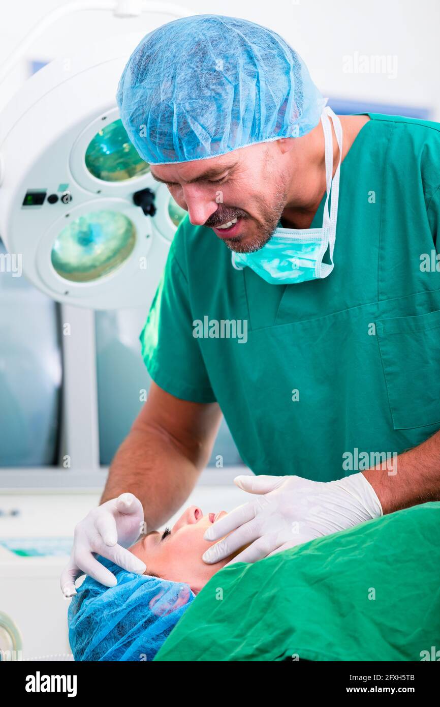 Doctor in operation at patient in operating room Stock Photo - Alamy
