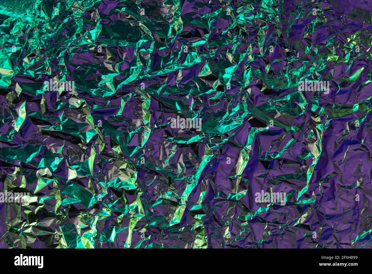 Chrome foil texture with crumpled structure effect. Green and violet ...