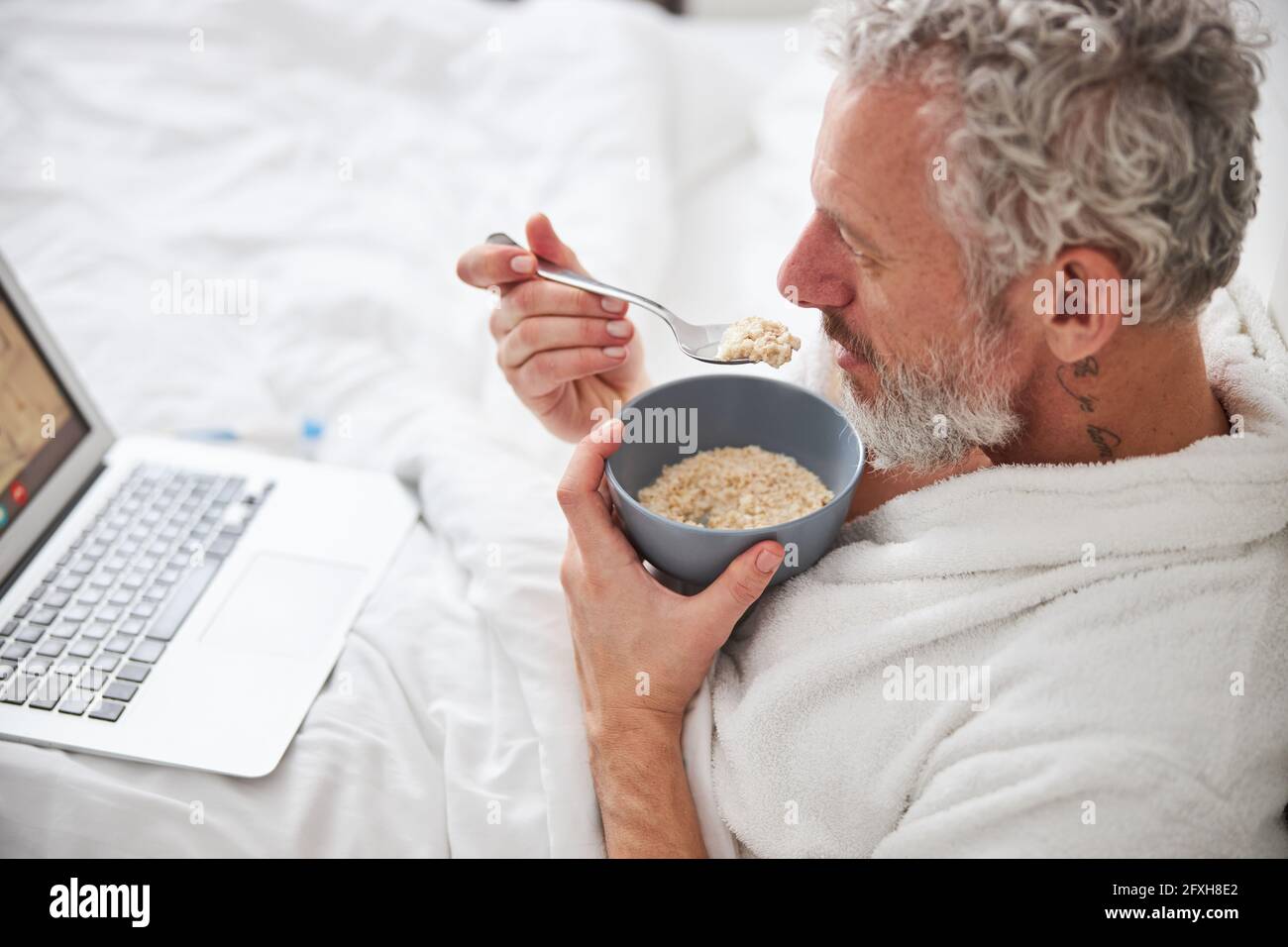 Senior man eating healthy oatmeal hi-res stock photography and images ...