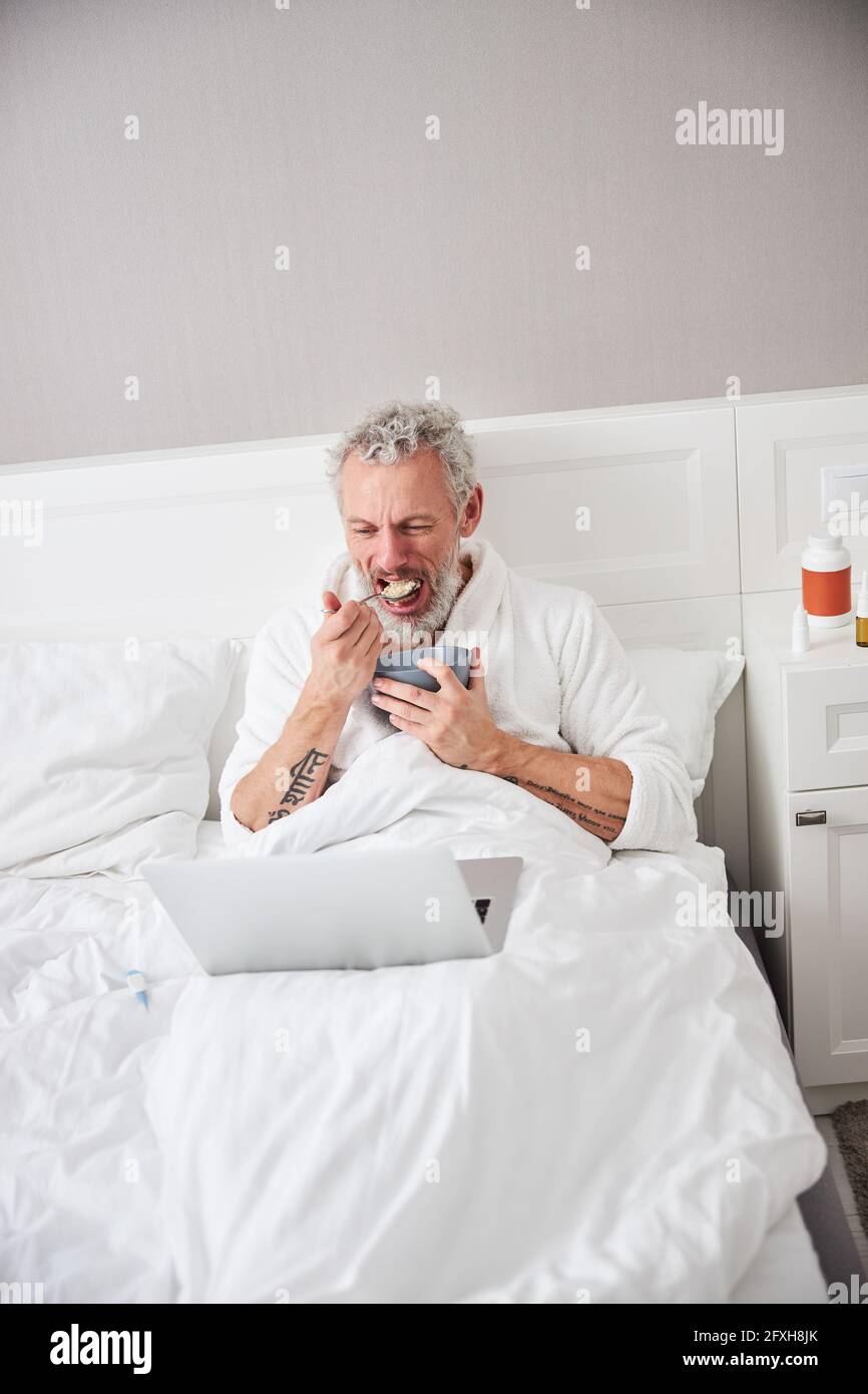 Senior man eating healthy oatmeal hi-res stock photography and images ...