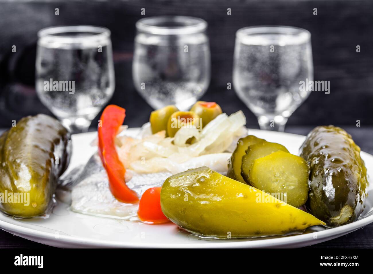 Marinated herring, cucumber and vodka shot Stock Photo - Alamy