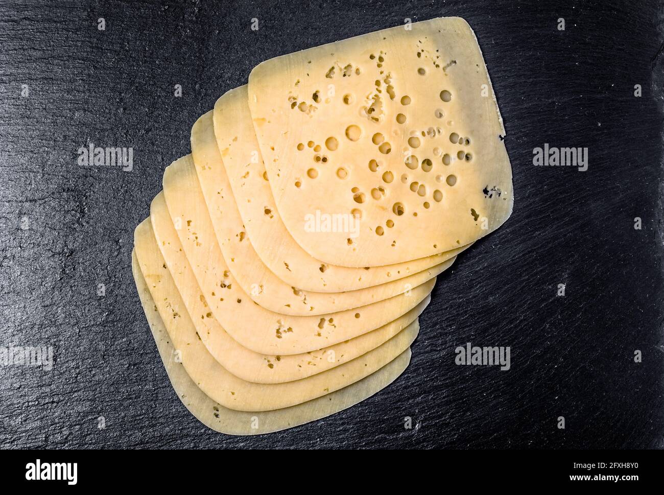 Yellow cheese slices Stock Photo - Alamy