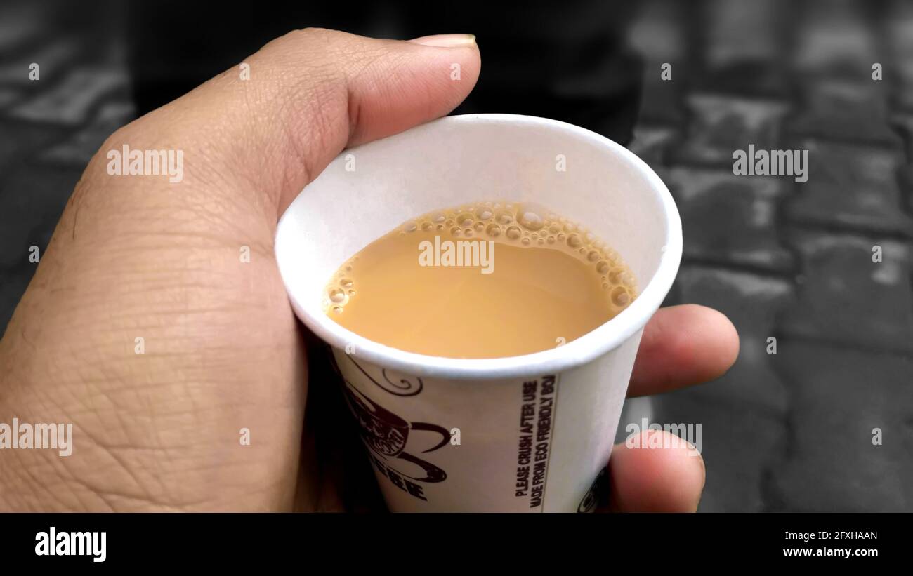 boy holding a cup of tea in the morning upon waking up in india Stock ...