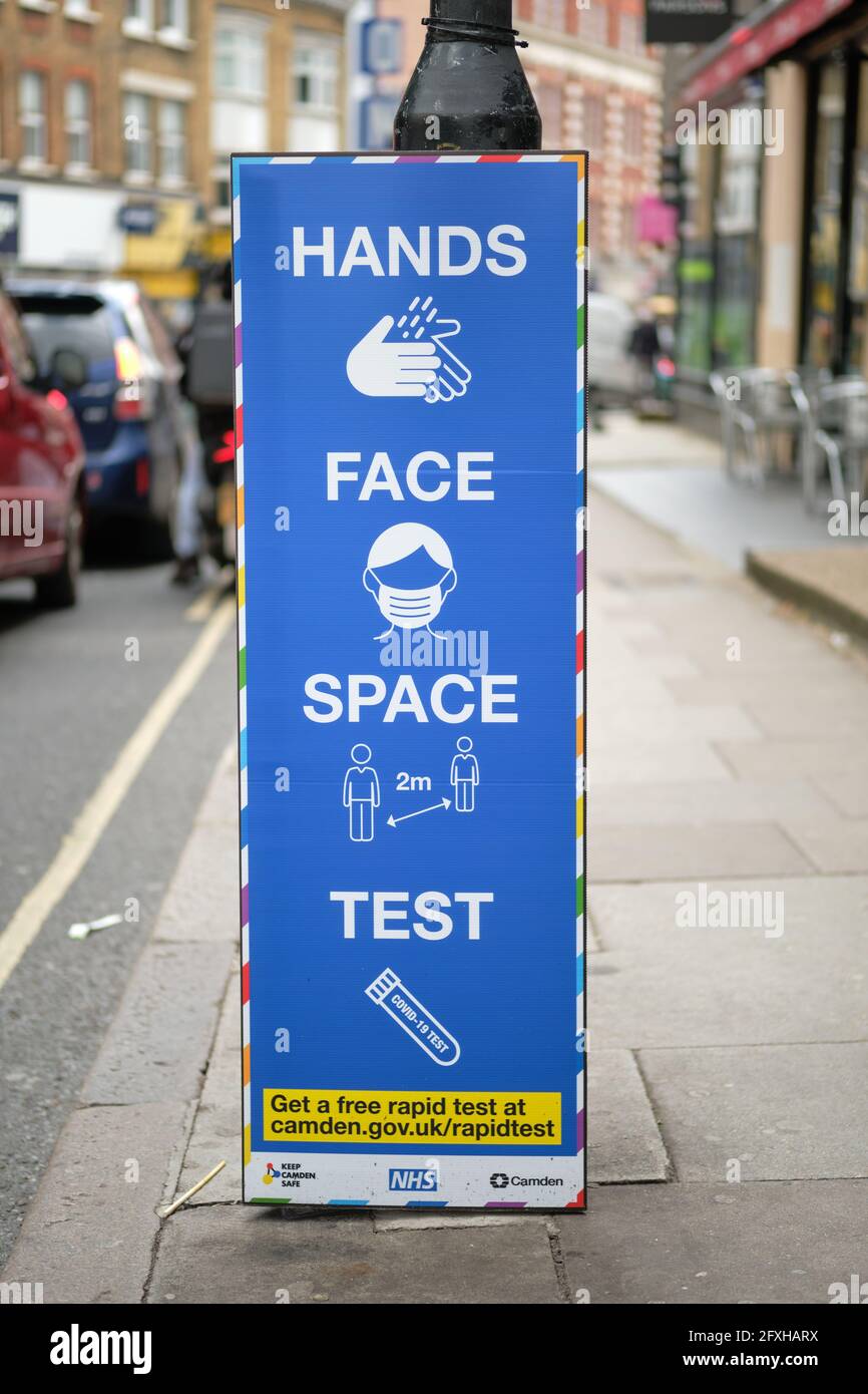 Close-up of blue COVID-19 test sign that reads: HANDS FACE SPACE TEST ...
