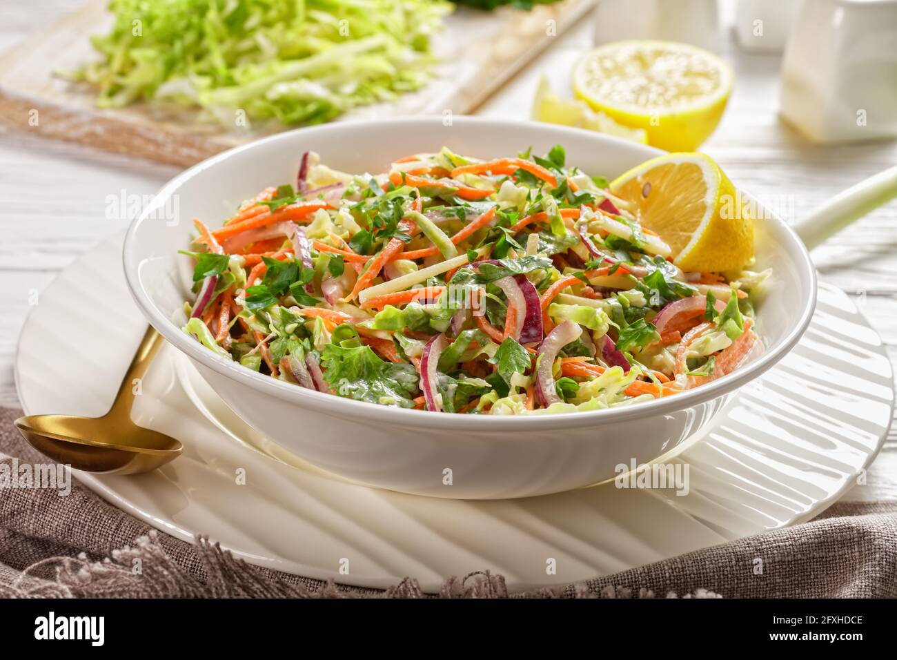 fresh summer coleslaw salad with light yogurt dressing in a white bowl ...