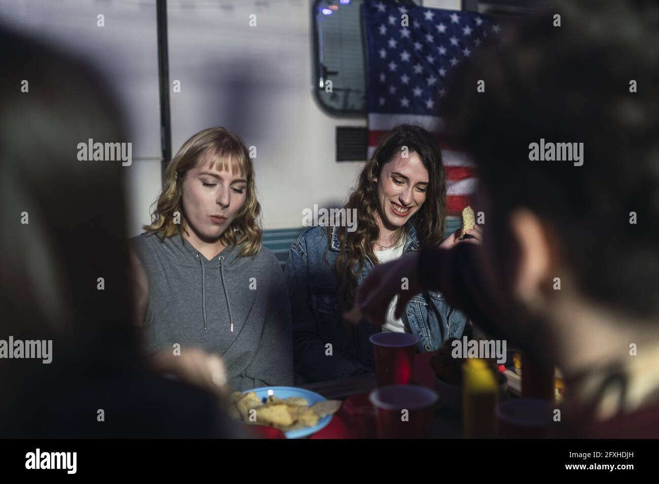 Young Spanish females enjoying their time during BBQ picnic on US ...