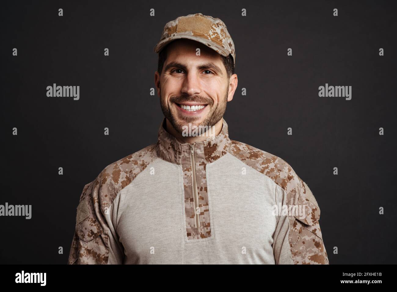 Happy masculine military man smiling and looking at camera isolated ...