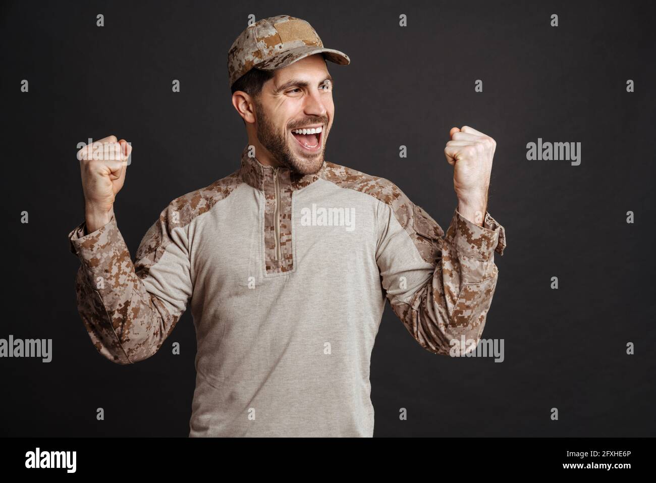 Excited masculine military man screaming and making winner gesture ...