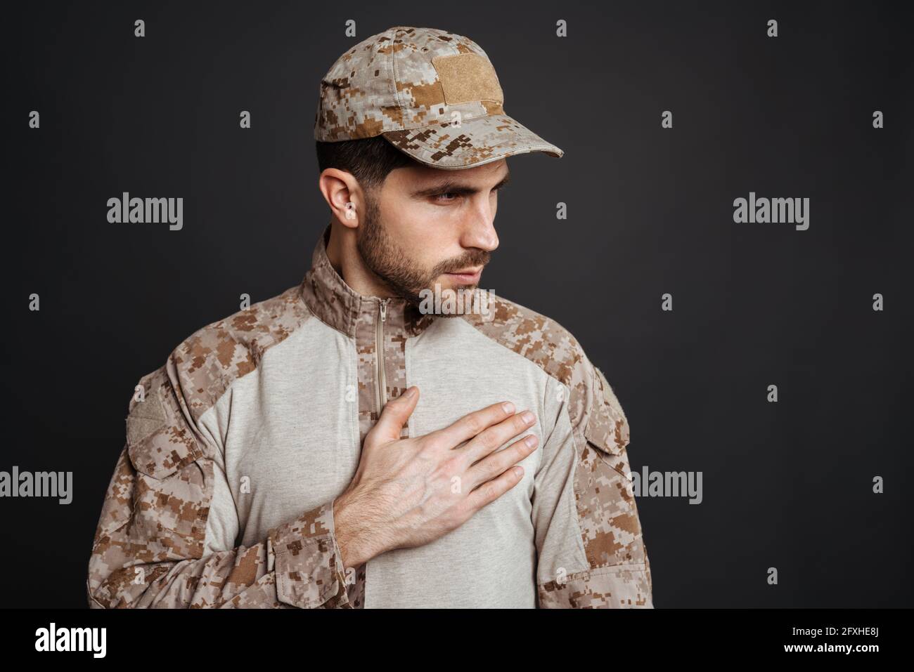 Confident masculine military man holding hand on his chest isolated ...