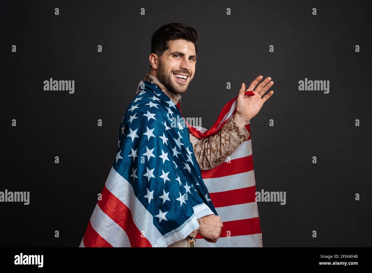 Happy masculine military man with american flag waving hand isolated ...