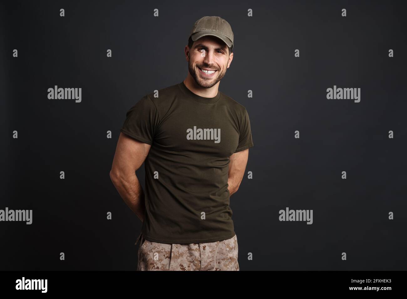 Happy masculine military man smiling and looking at camera isolated ...