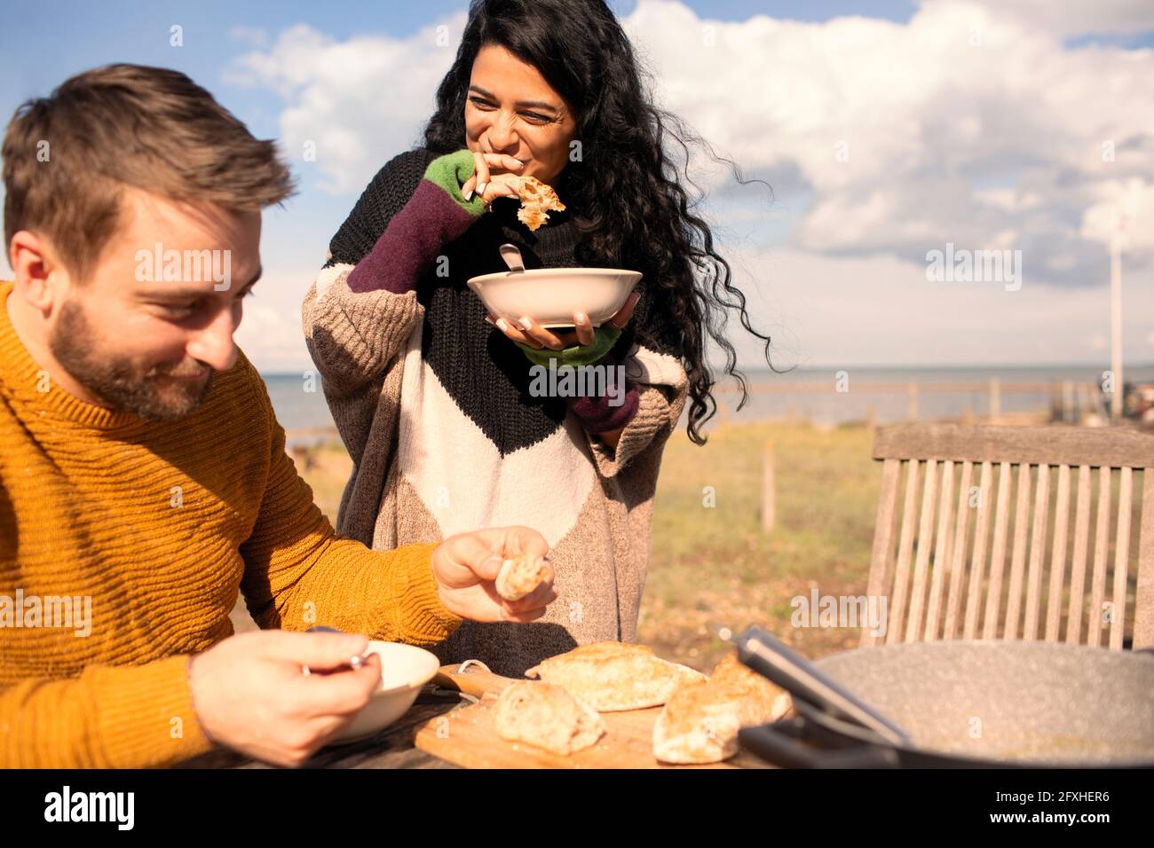 Couple eating food standing hi-res stock photography and images - Alamy