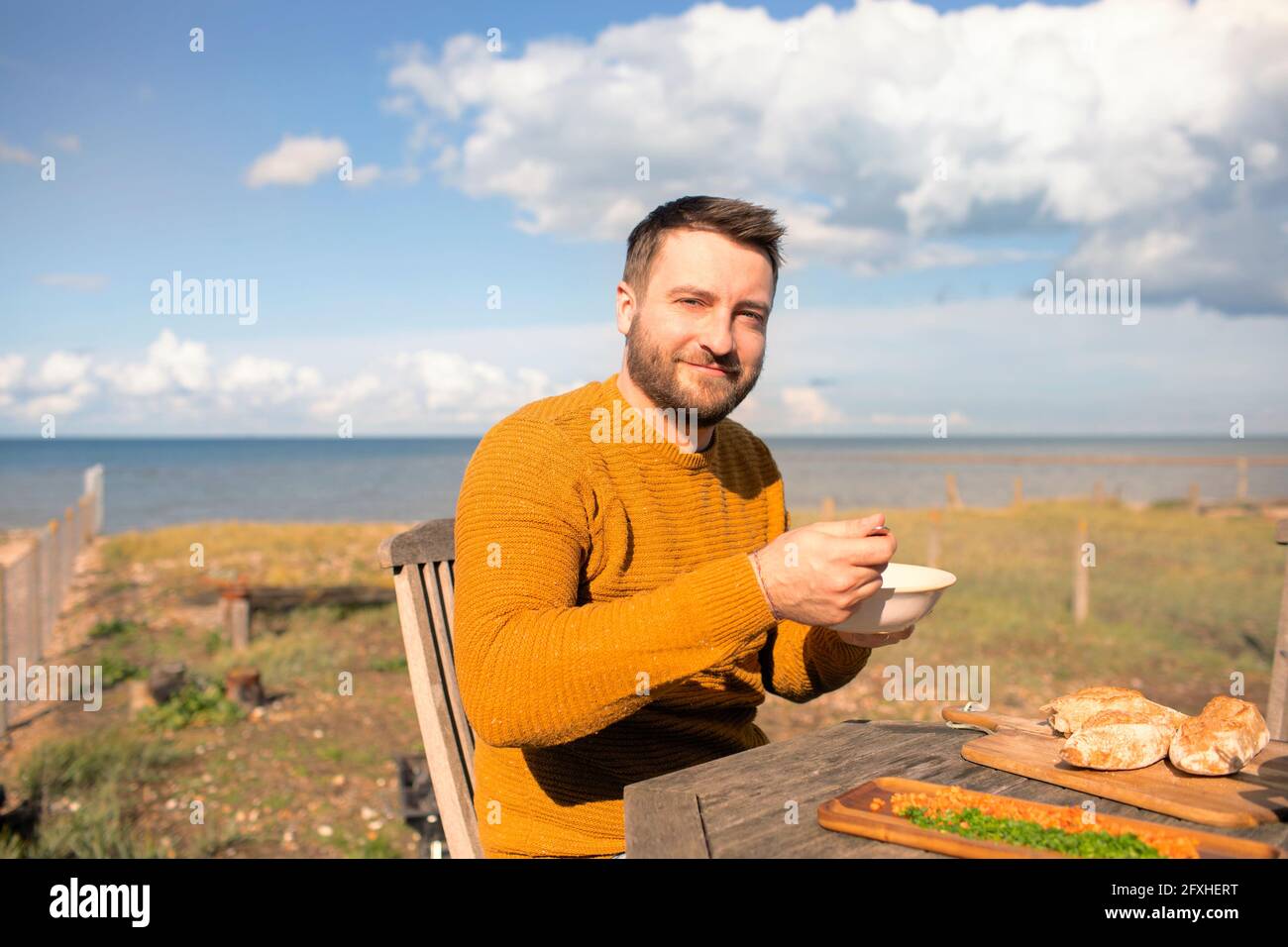 Man beach eating bread hi-res stock photography and images - Alamy