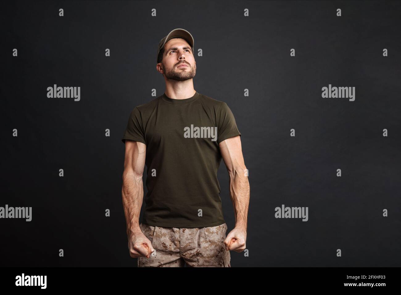 Confident masculine military man posing and looking upward isolated ...