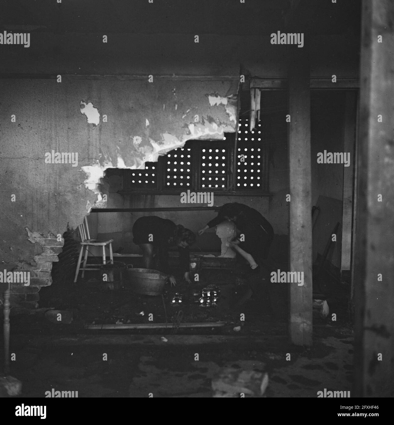 [women are cleaning something, photo taken through the open façade of a ...