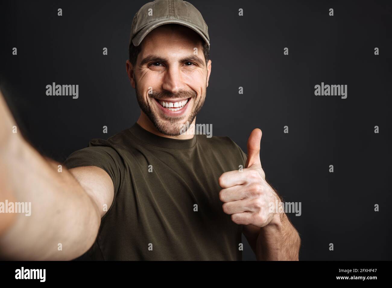 Happy military man taking selfie photo while showing thumb up isolated ...