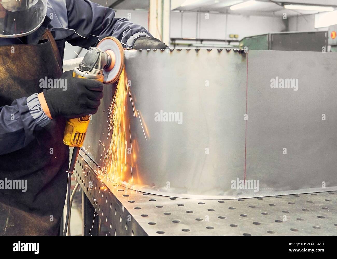Metal cutting with angle grinder. Man welder cuts metals. Sparks in ...