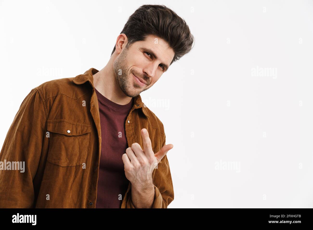 Happy handsome young man calling somebody with finger isolated over ...
